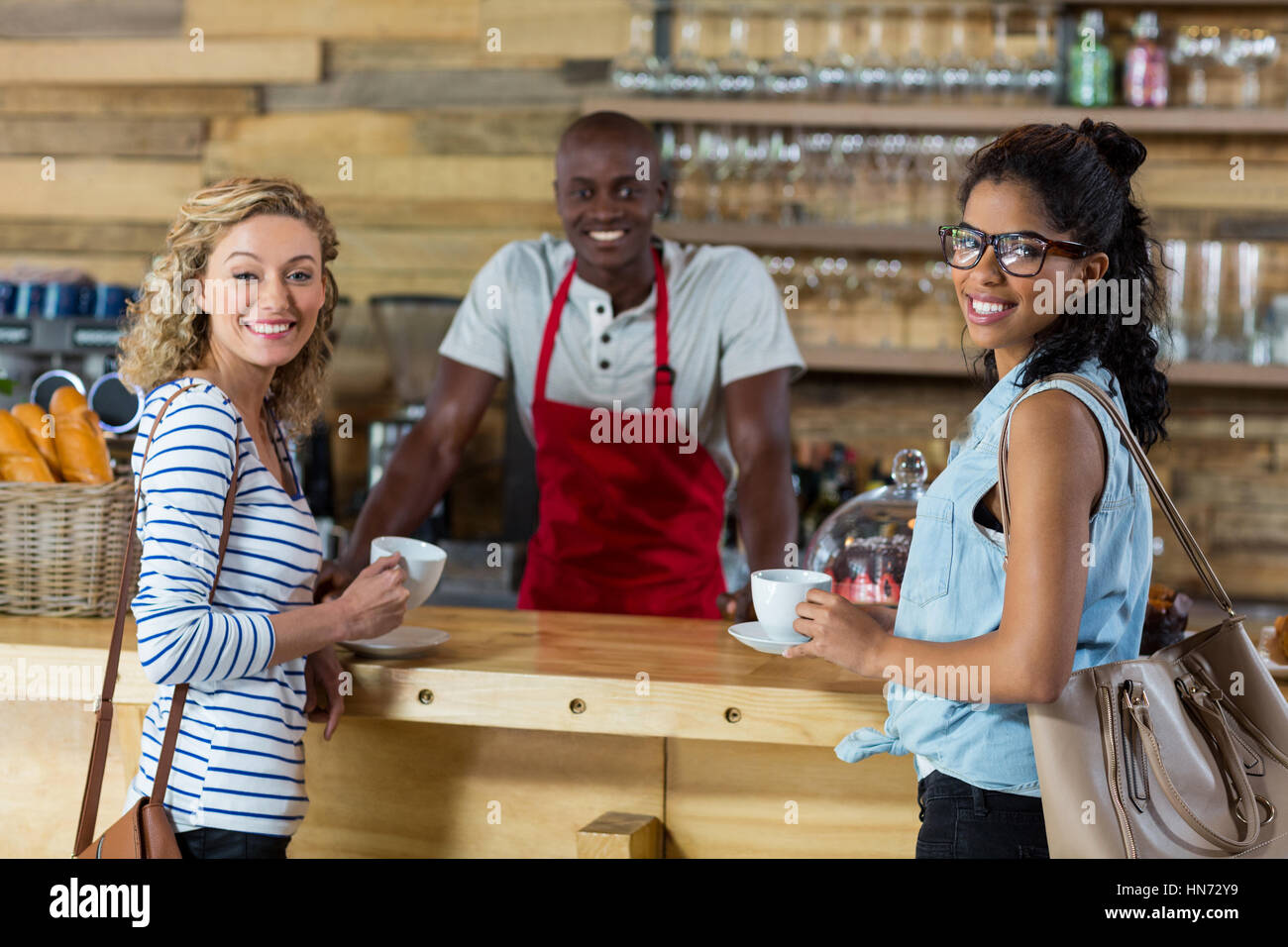 Waiter serving coffee to female customer in cafÃƒÂ© Stock Photo - Alamy