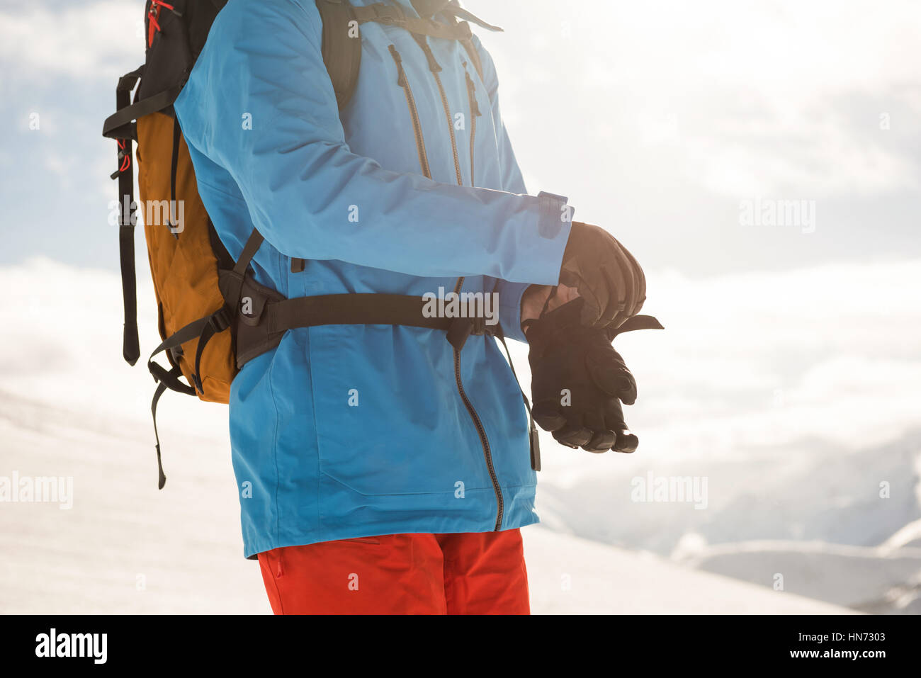 Skier wearing hand gloves while getting ready for skiing Stock Photo ...