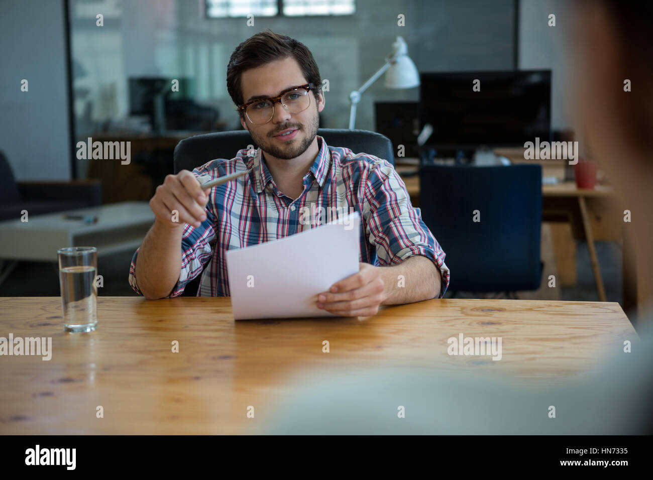 Business executive conducting job interview with woman in office Stock ...