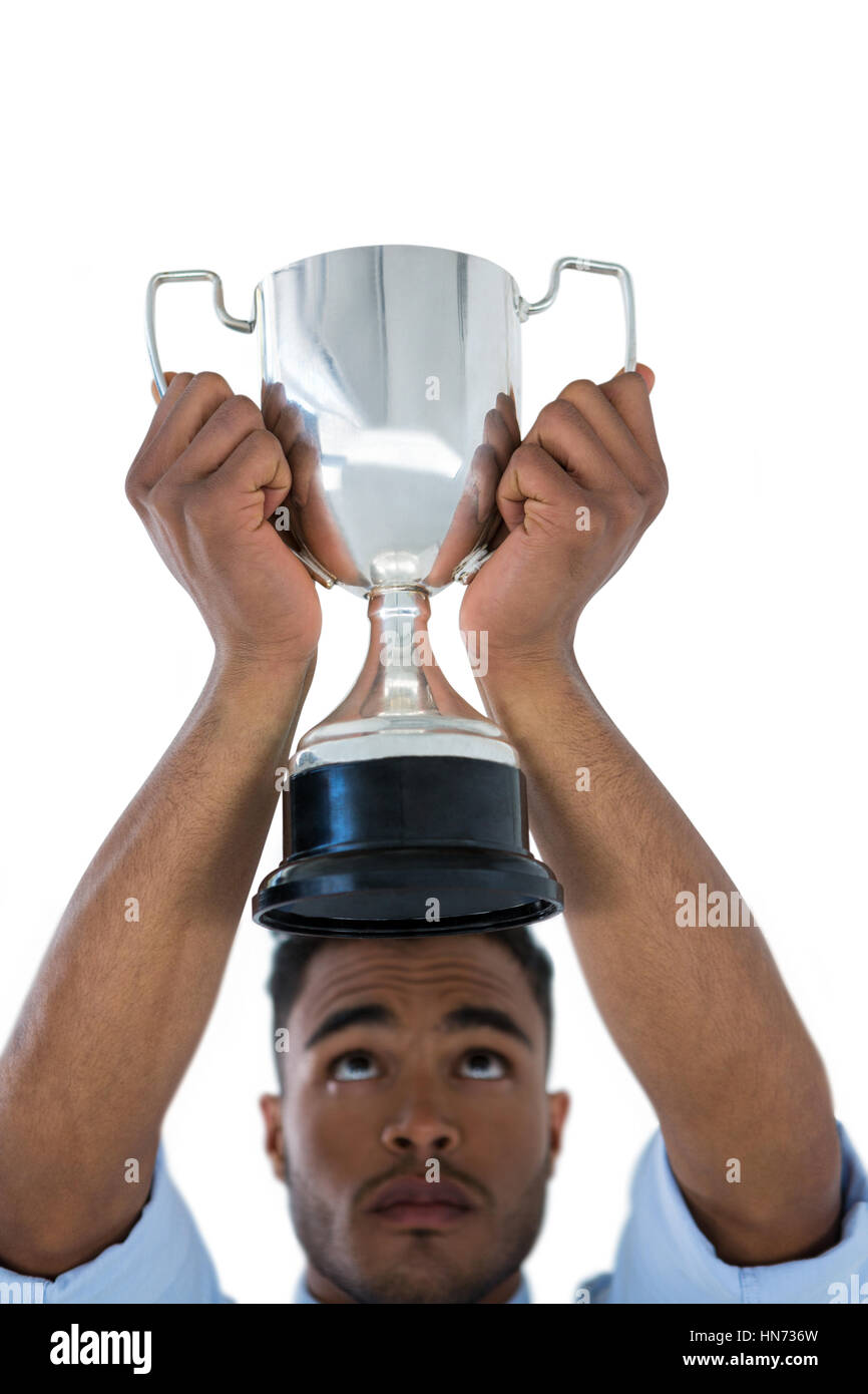 Close-up of businessman lifting a trophy against white background Stock ...
