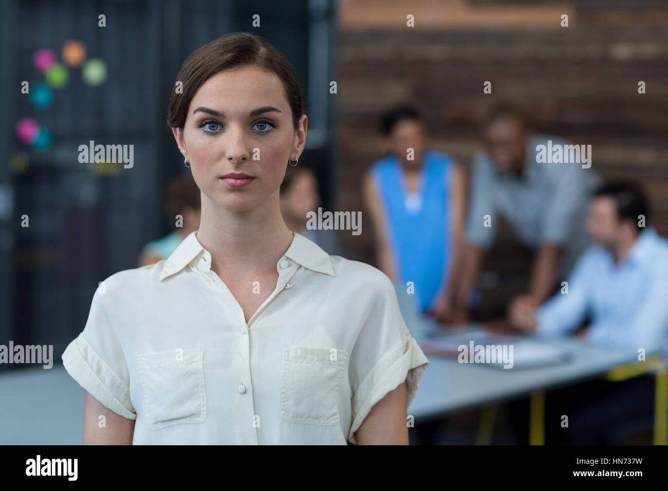 Portrait of confident business executive standing in office Stock Photo ...