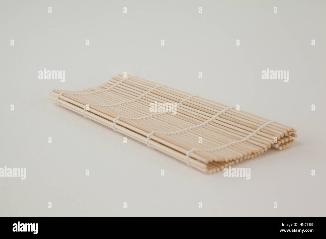 Straw sushi mat against white background Stock Photo - Alamy