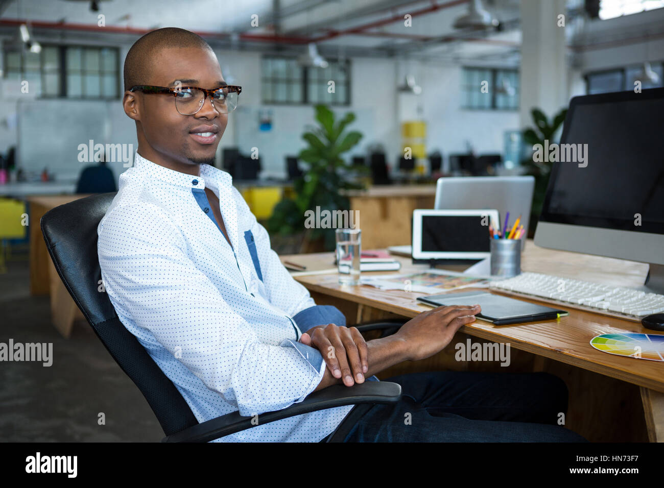 Portrait of graphic designer at desk in office Stock Photo - Alamy
