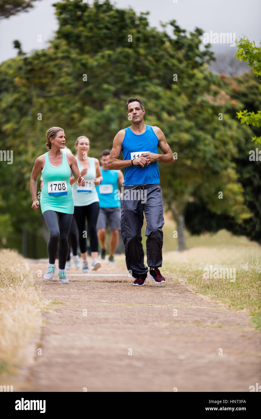 Athletes running race in park on sunny a day Stock Photo - Alamy