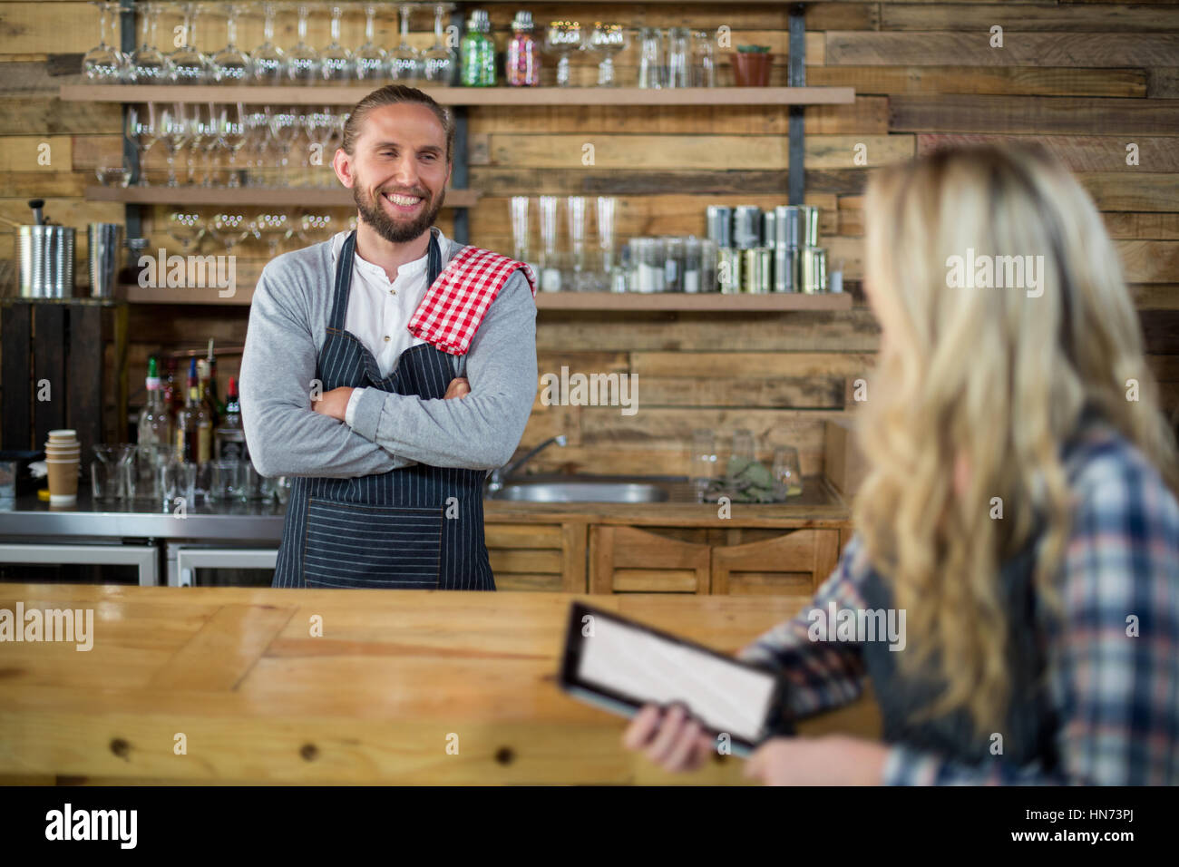Smiling waitress and waiter interacting at counter in cafÃƒÂ© Stock ...
