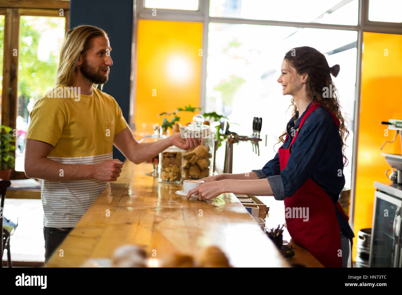 Woman counter cash receiving hi-res stock photography and images - Alamy