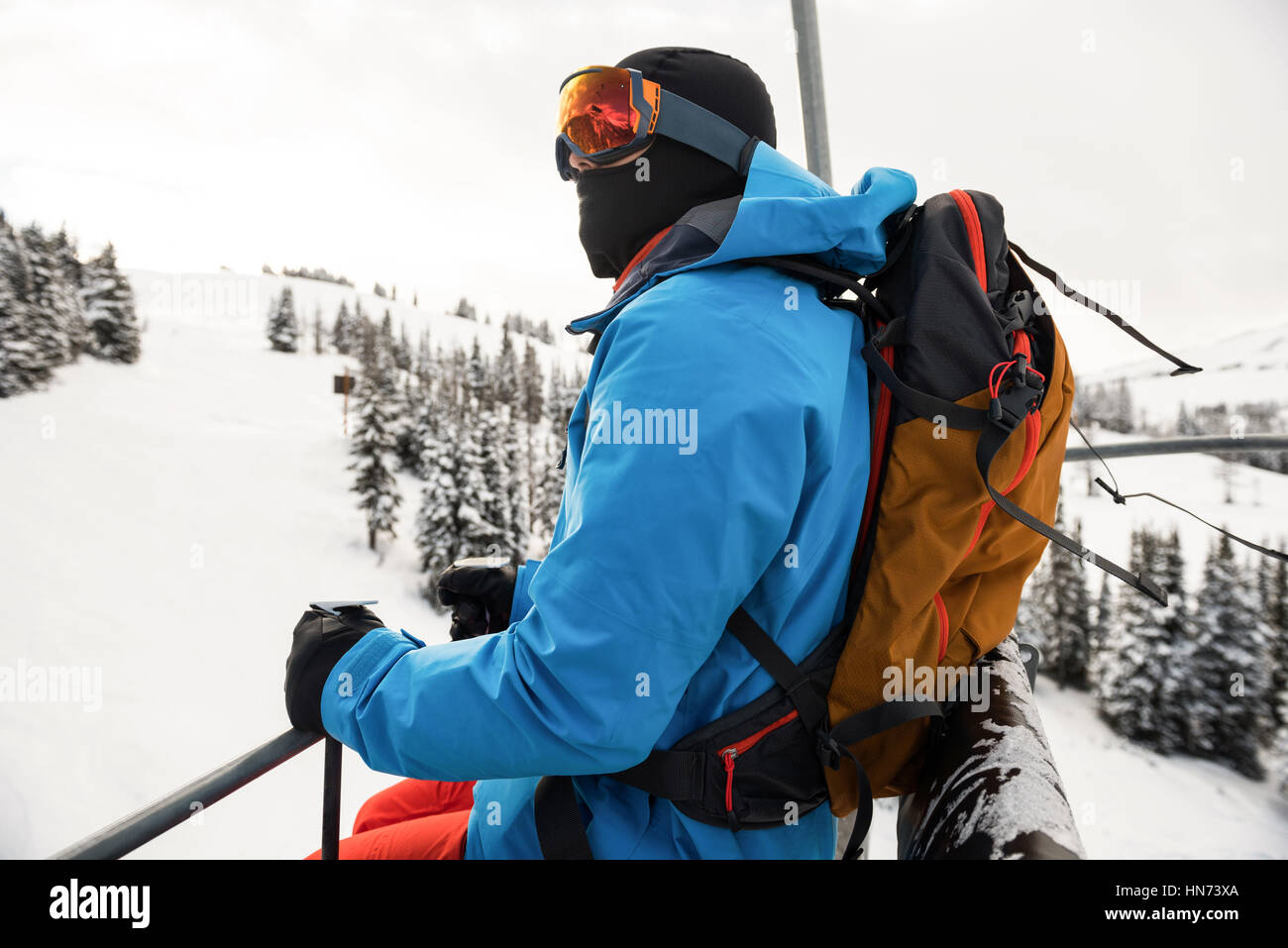 Side view of skier looking at beautiful snow-covered mountains Stock ...