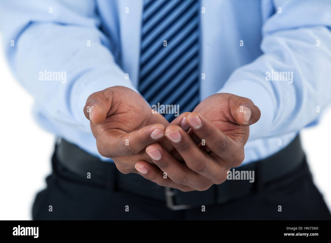 Mid section of mans hands cupped against white background Stock Photo ...