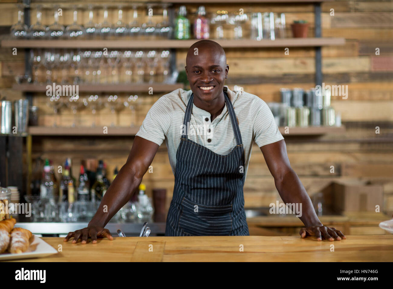 Portrait of smiling waiter standing at counter in cafÃƒÂ© Stock Photo ...