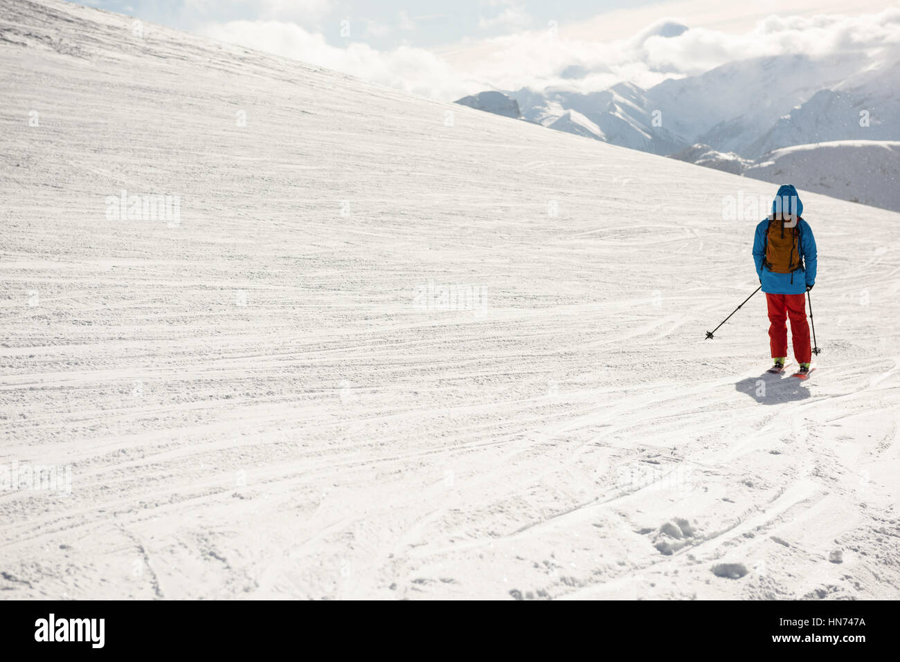 Rear view of skier skiing on snow covered mountains Stock Photo - Alamy