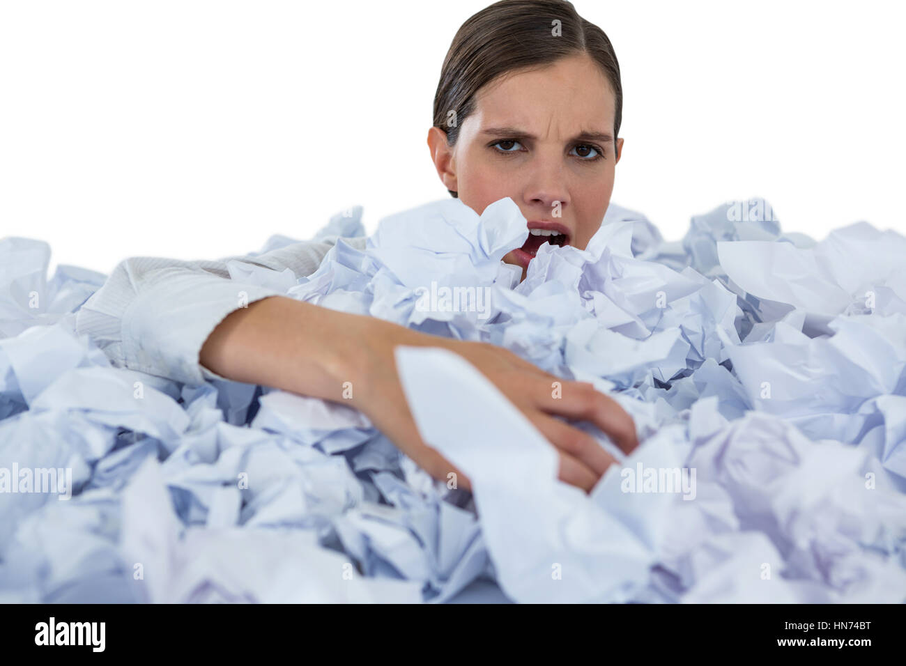 Portrait of unhappy businesswoman in heap crumpled paper against white ...