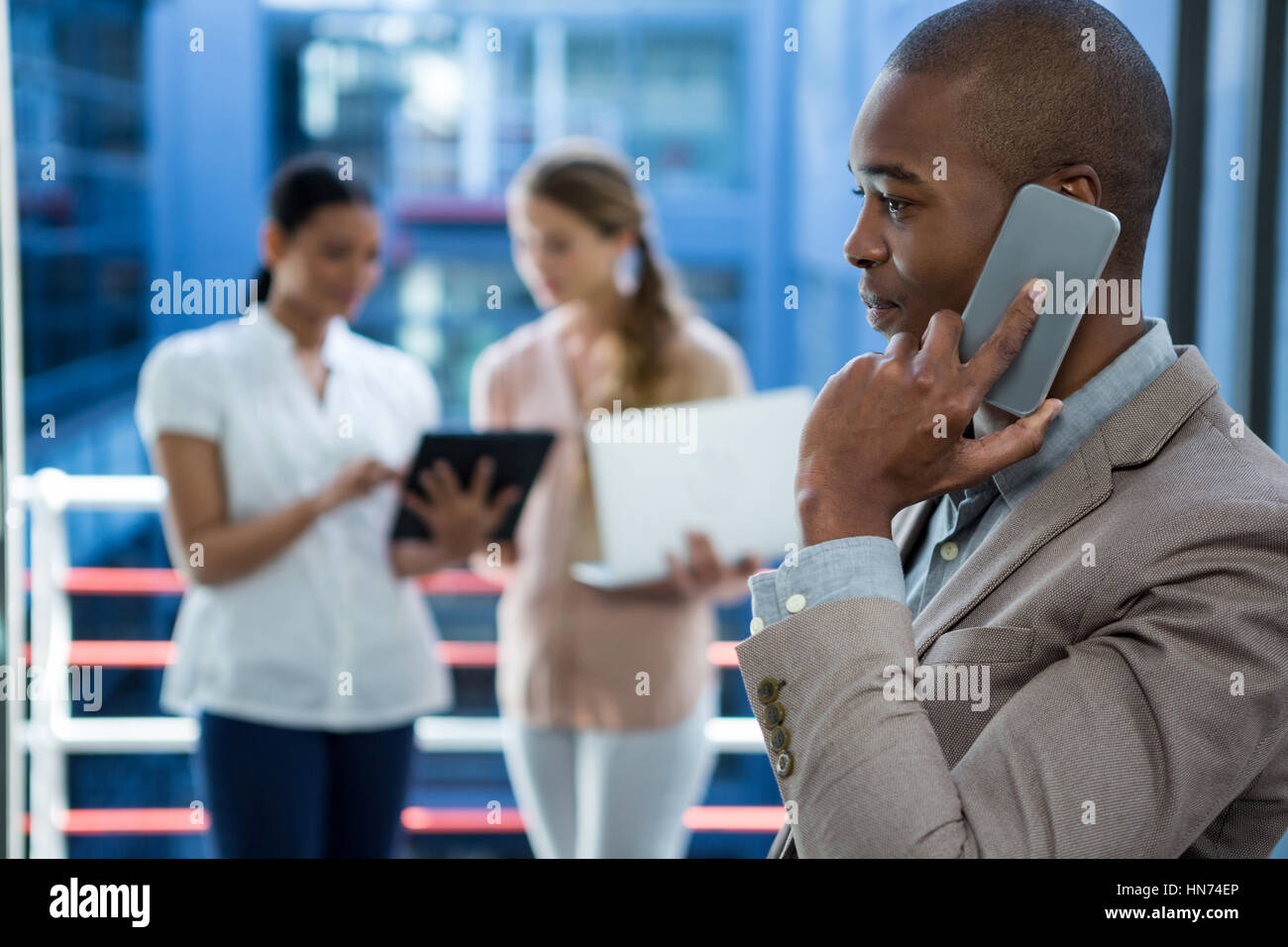 Business executive talking on mobile phone in office Stock Photo - Alamy