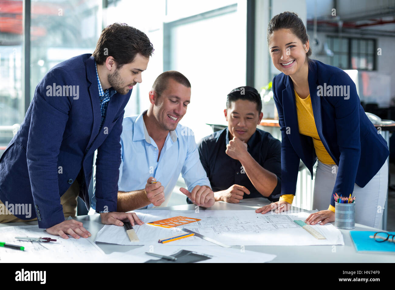 Businesspeople having discussion over document in office Stock Photo ...