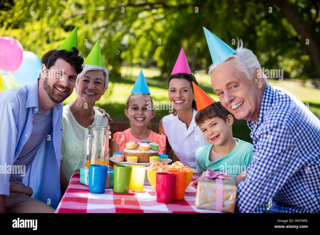 Portrait of happy multigeneration family celebrating birthday party in ...