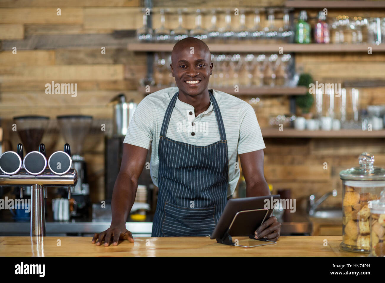 Portrait of smiling waiter standing at counter in cafÃƒÂ© Stock Photo ...