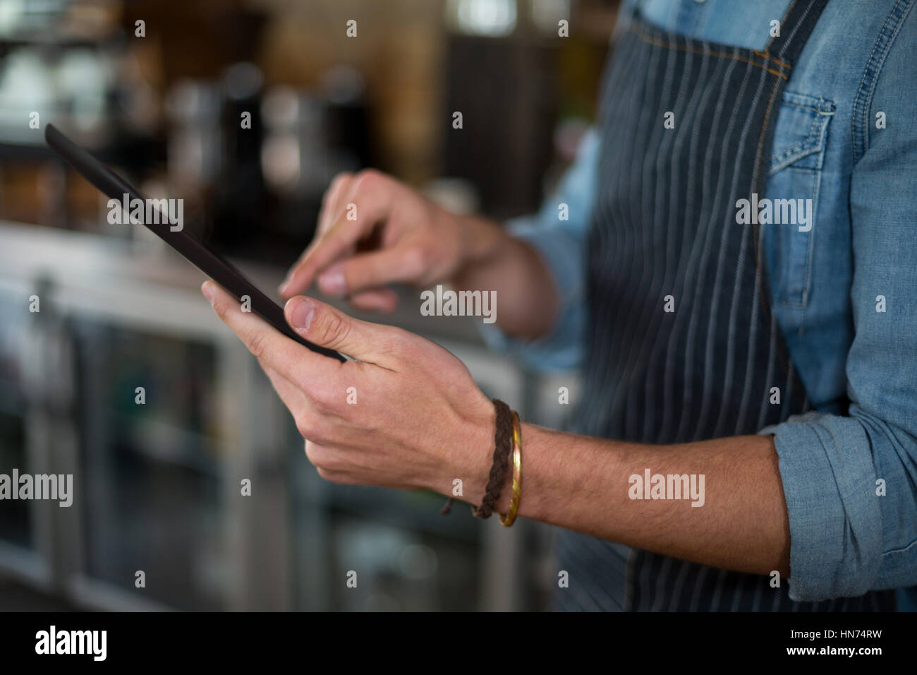 Mid section of waiter using digital tablet in cafÃƒÂ© Stock Photo - Alamy