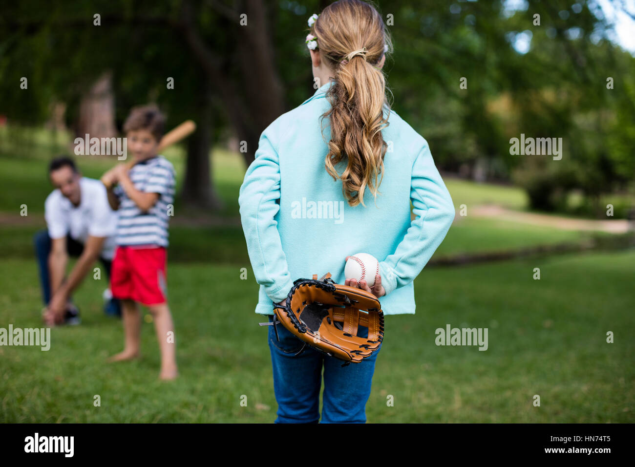 Happy family playing baseball in the park Stock Photo - Alamy