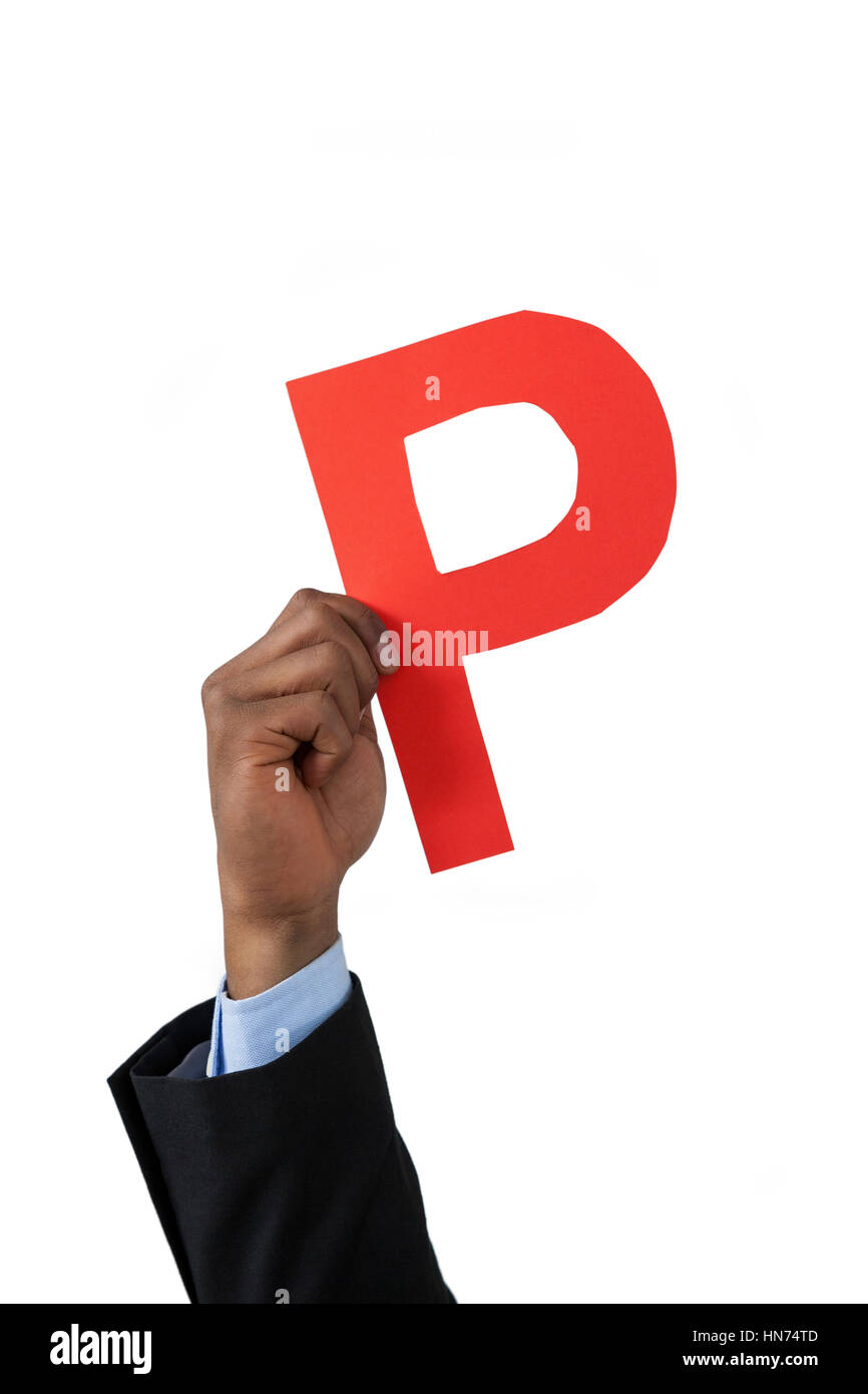 Close-up of businessman holding alphabet p against white background ...