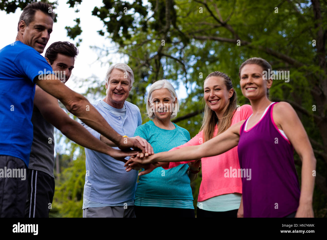 Group of people doing a hand stack in park Stock Photo - Alamy