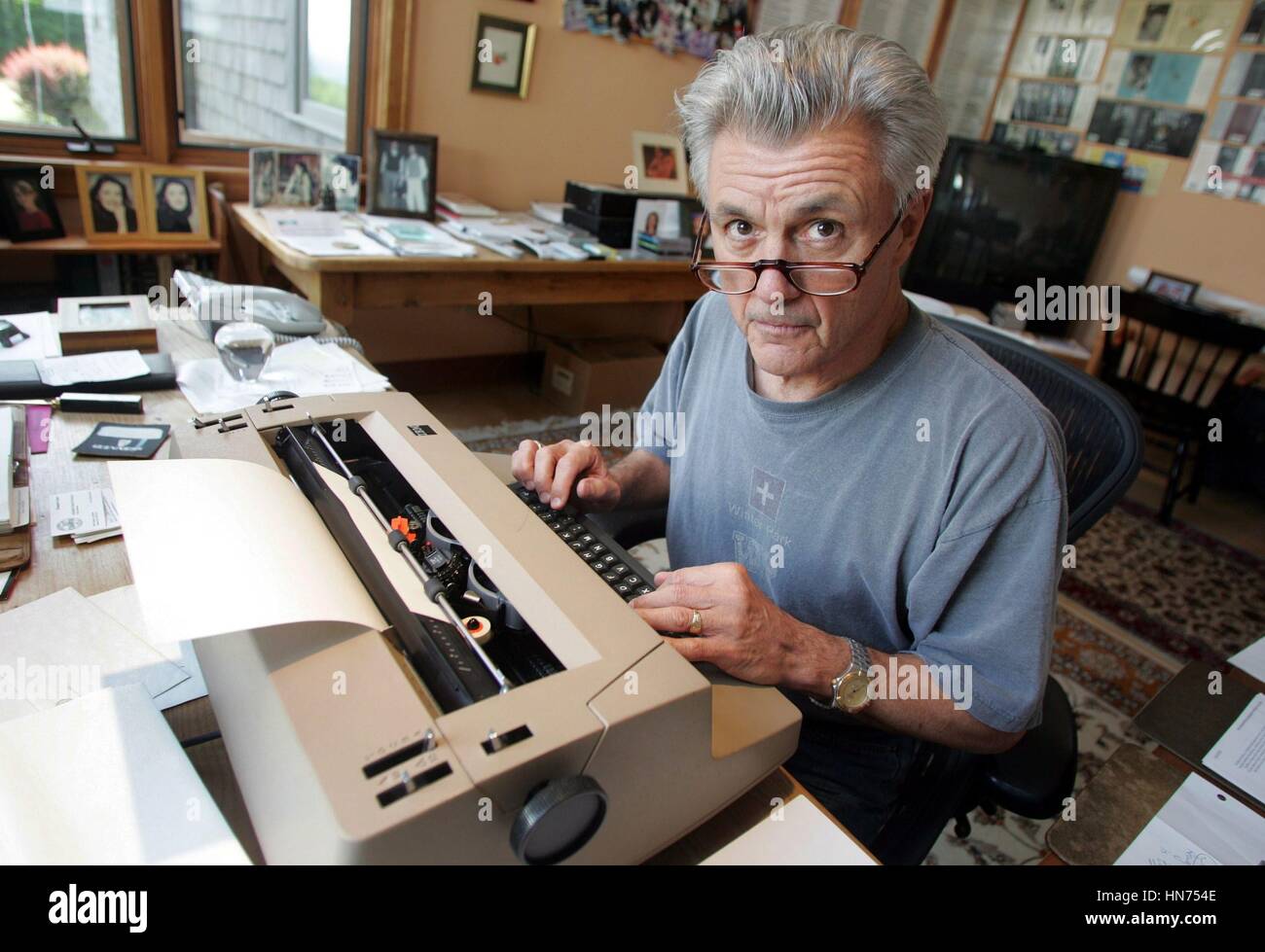 Author, John Irving, is seen behind the old IBM Selectric that he uses ...