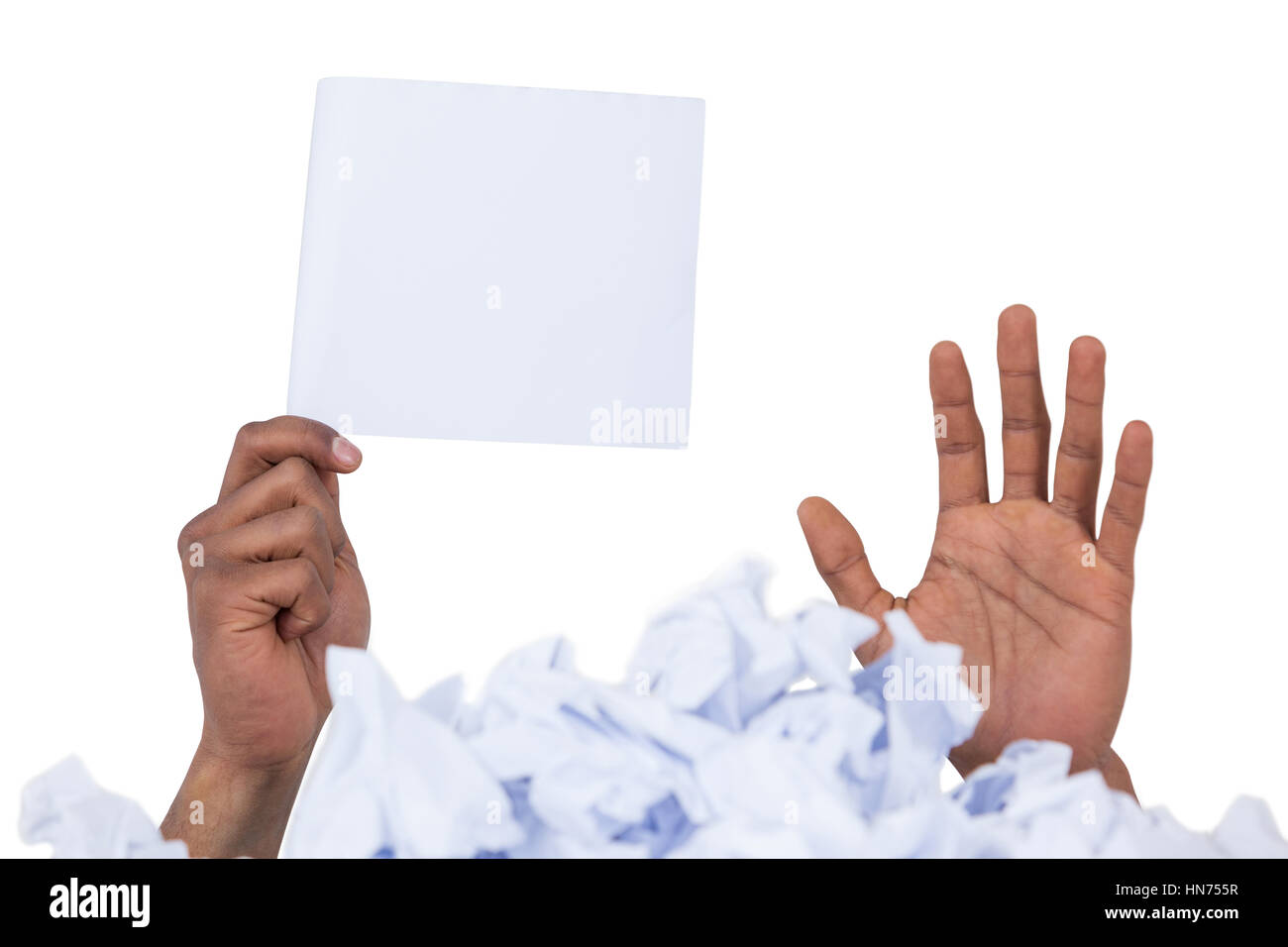 Heap of crumpled paper with hand holding blank page on white background ...