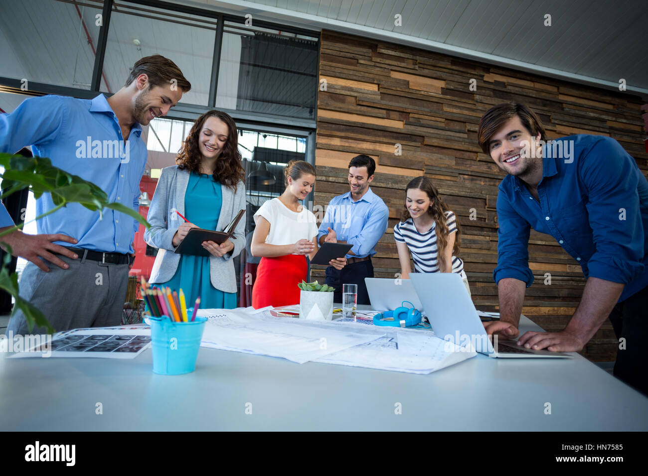 Team of graphic designers working together in office Stock Photo - Alamy