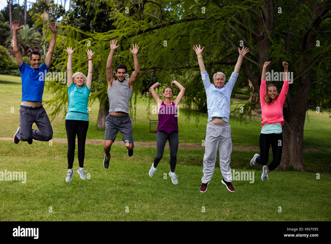 Group of people exercising together in park Stock Photo - Alamy