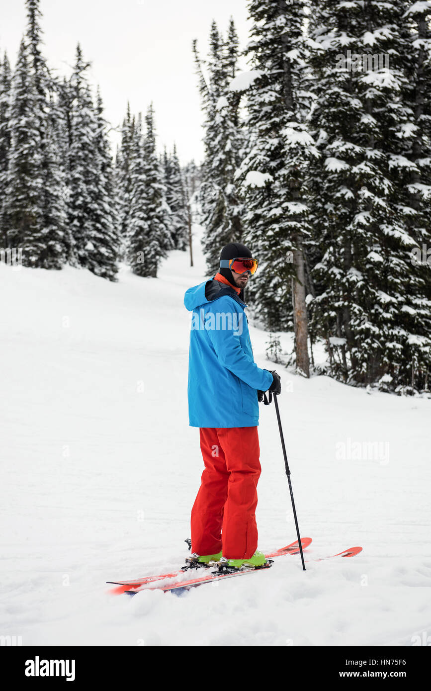 Side view of skier skiing on snow covered mountains Stock Photo - Alamy