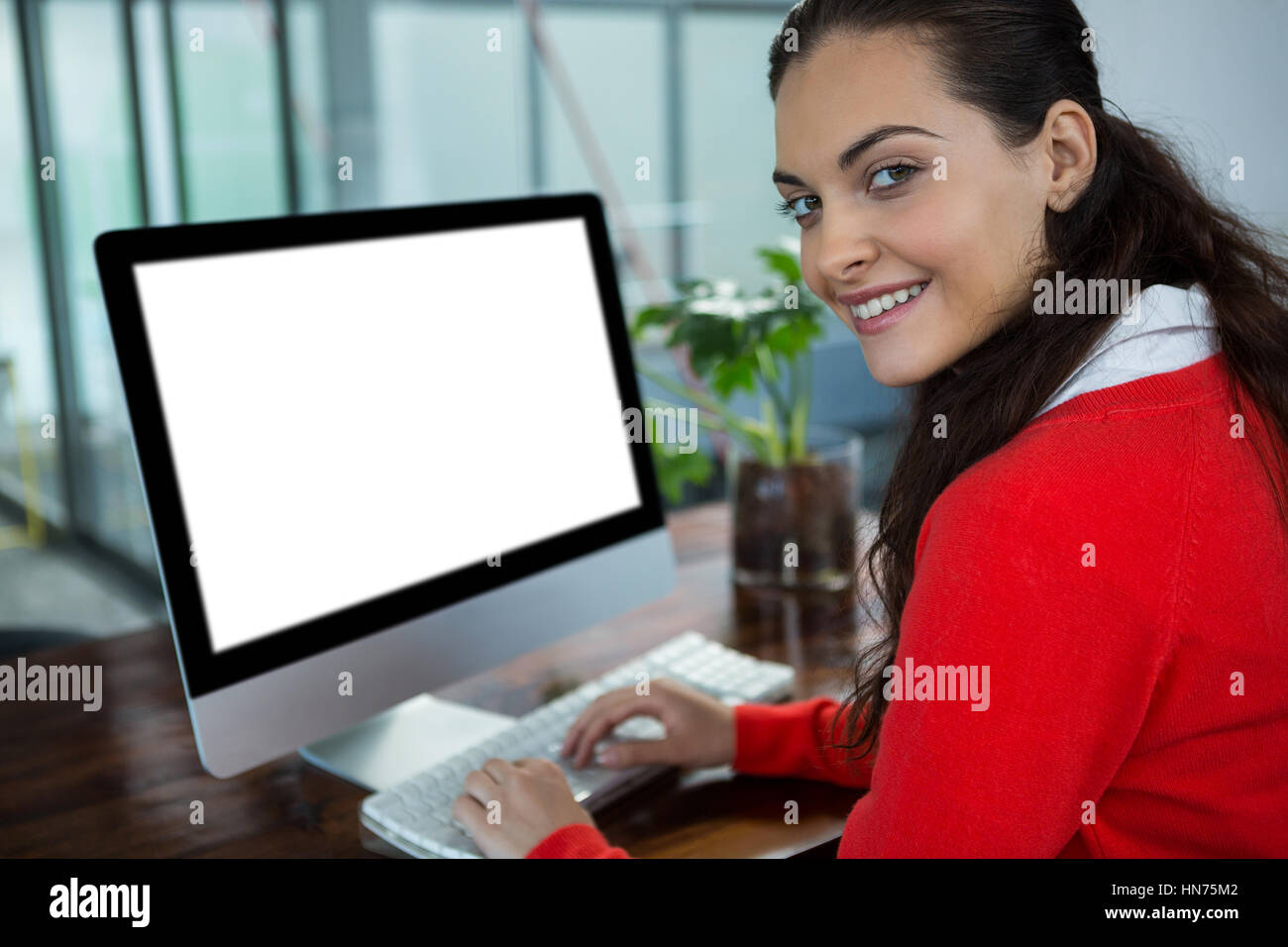 Portrait of a female business executive sitting desk in office Stock ...