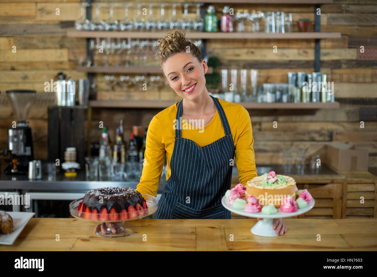 Portrait of smiling waitress standing with dessert in cafe Stock Photo ...