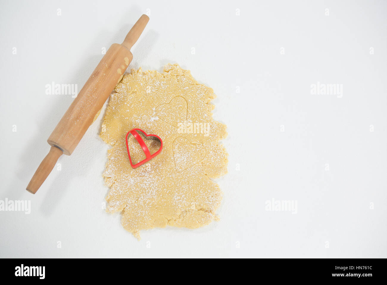 Rolling pin and cookie cutter on dough on white background Stock Photo ...