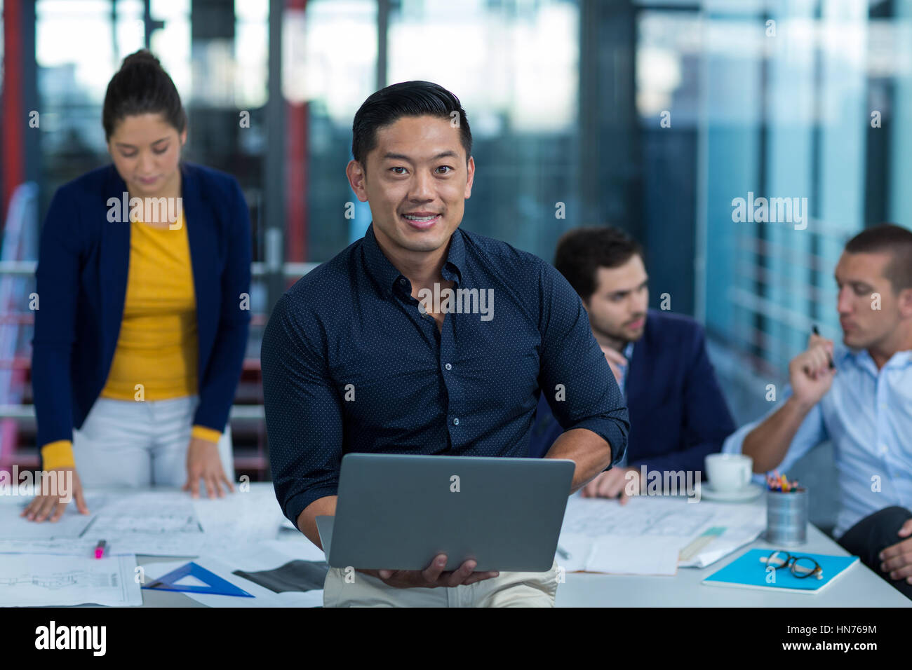 Male business executive using laptop in office Stock Photo - Alamy