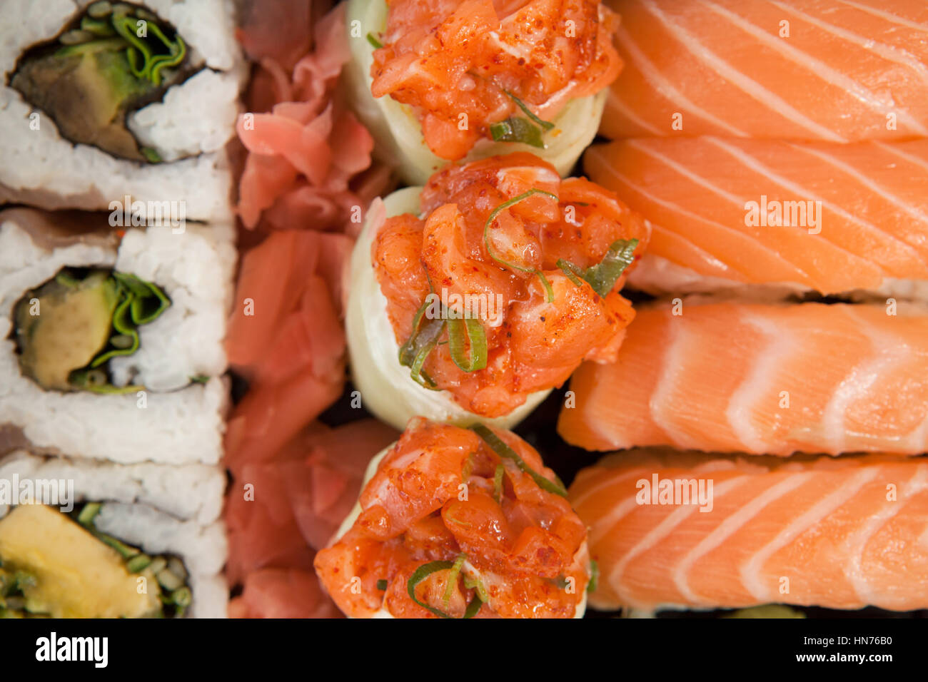 Close-up of assorted sushi set served in white box against white ...