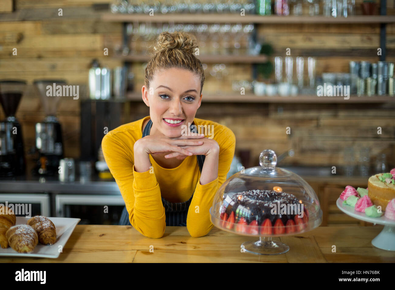 Portrait of smiling waitress leaning at counter in cafÃƒÂ© Stock Photo ...