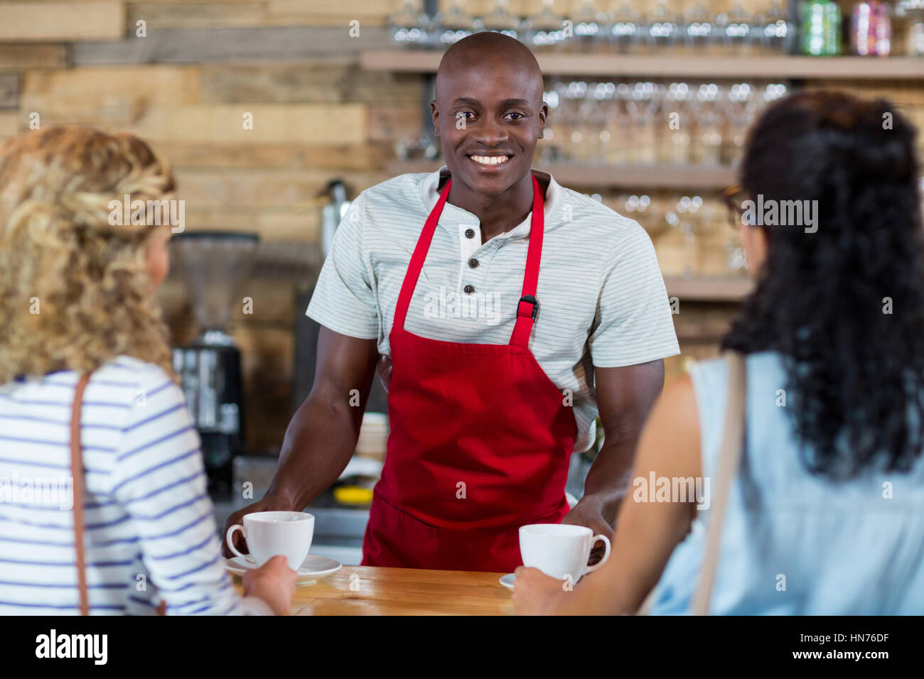 Waiter serving coffee to female customer in cafÃƒÂ© Stock Photo - Alamy