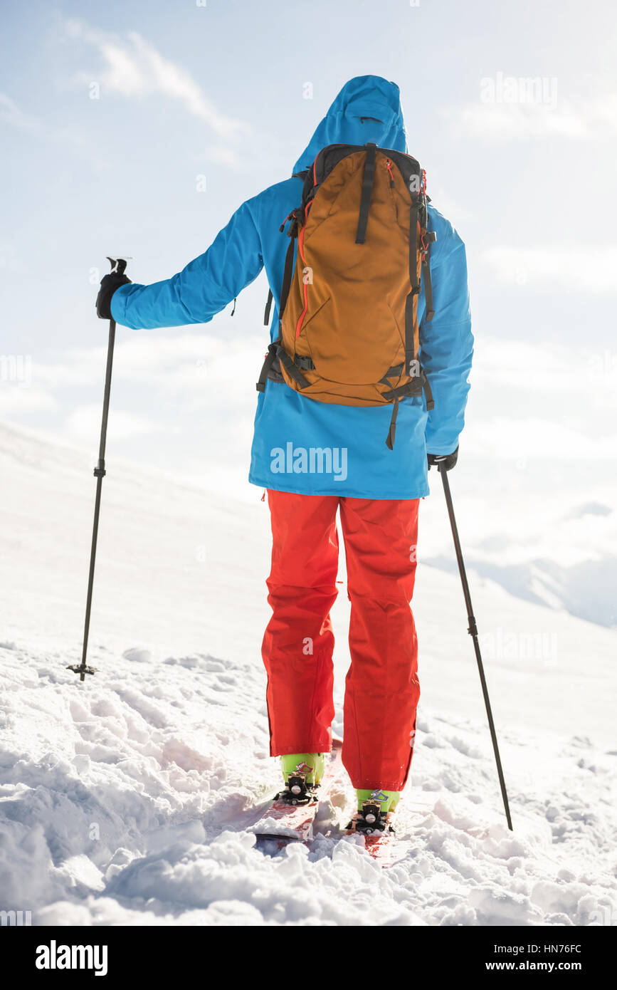 Rear view of skier walking on the slope with ski Stock Photo - Alamy