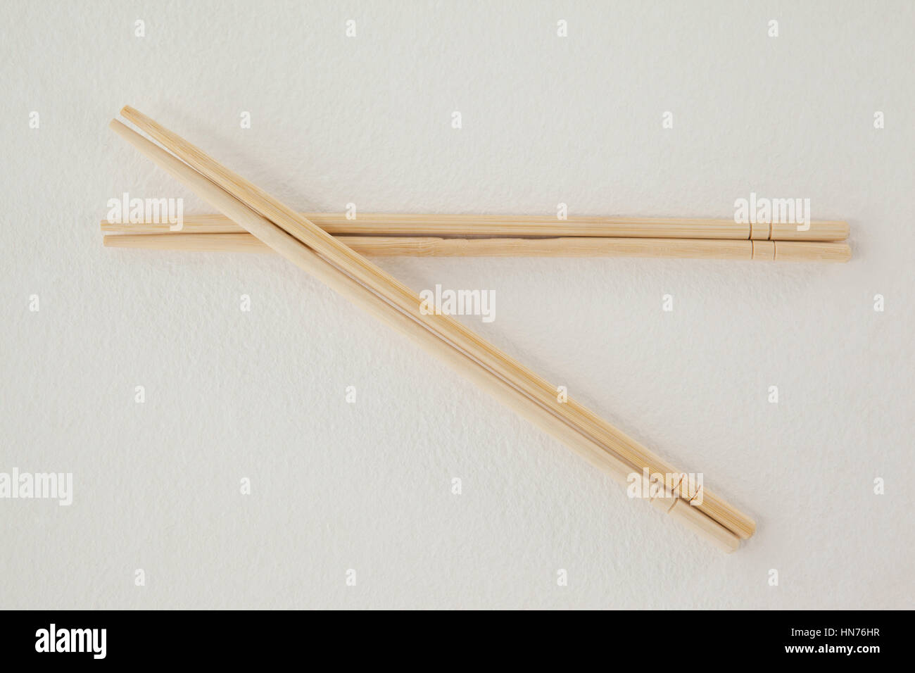 Pair of chopsticks against white background Stock Photo - Alamy