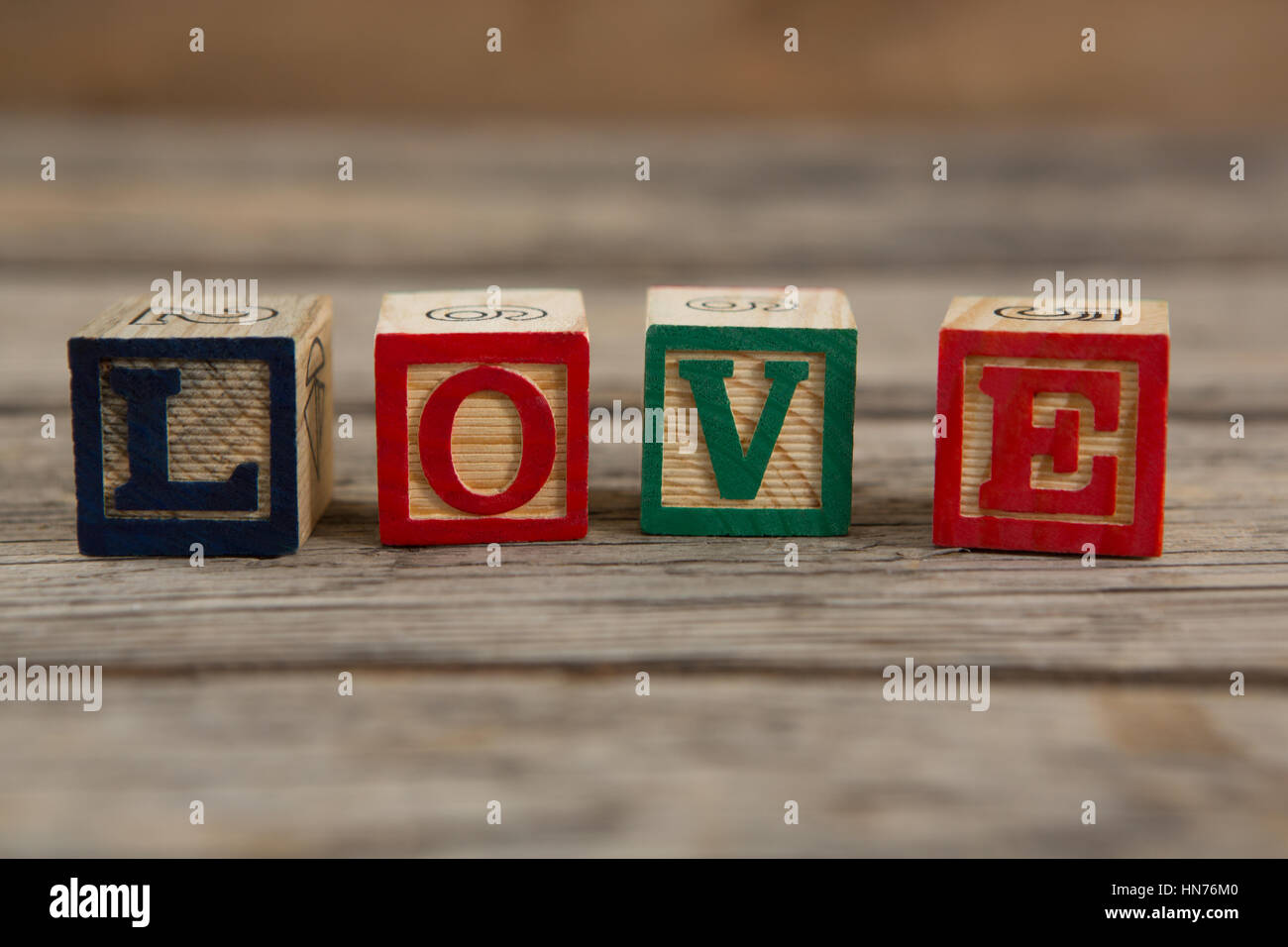 Blocks displaying love message on wooden surface Stock Photo - Alamy