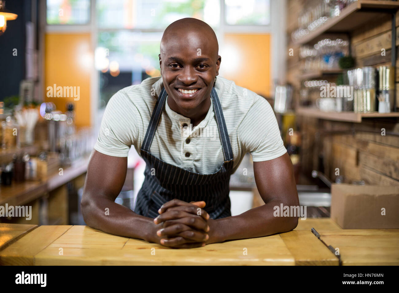 Portrait of smiling waiter standing at counter in cafÃƒÂ© Stock Photo ...