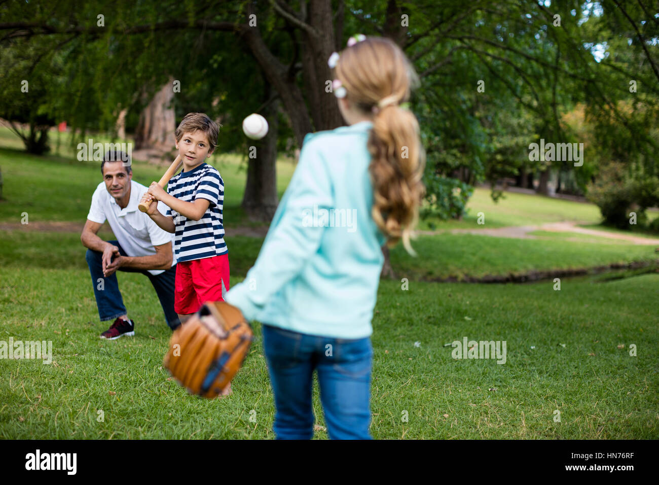 Happy family playing baseball in the park Stock Photo - Alamy