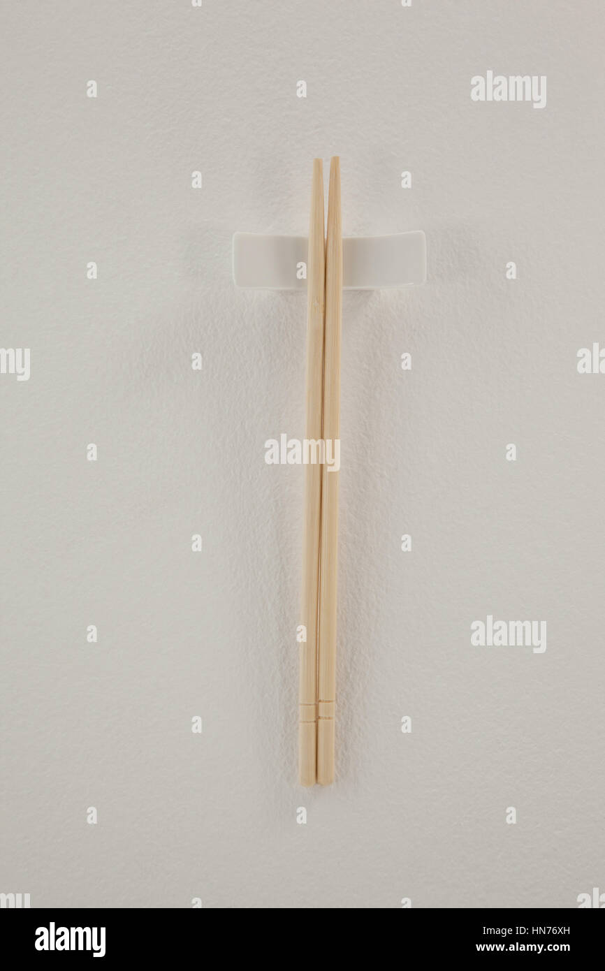 Pair of chopsticks against white background Stock Photo - Alamy