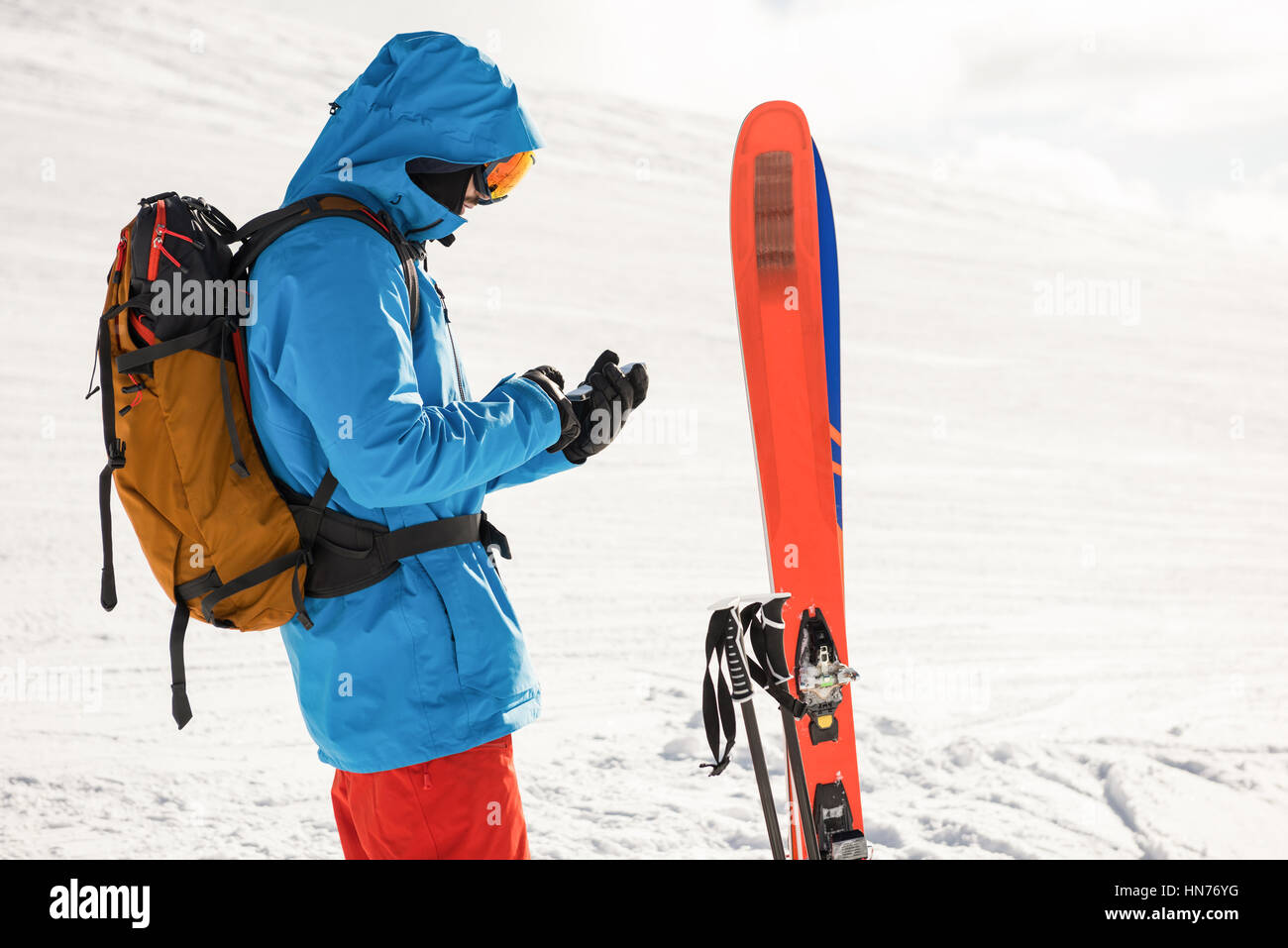 Side view skier using mobile hi-res stock photography and images - Alamy