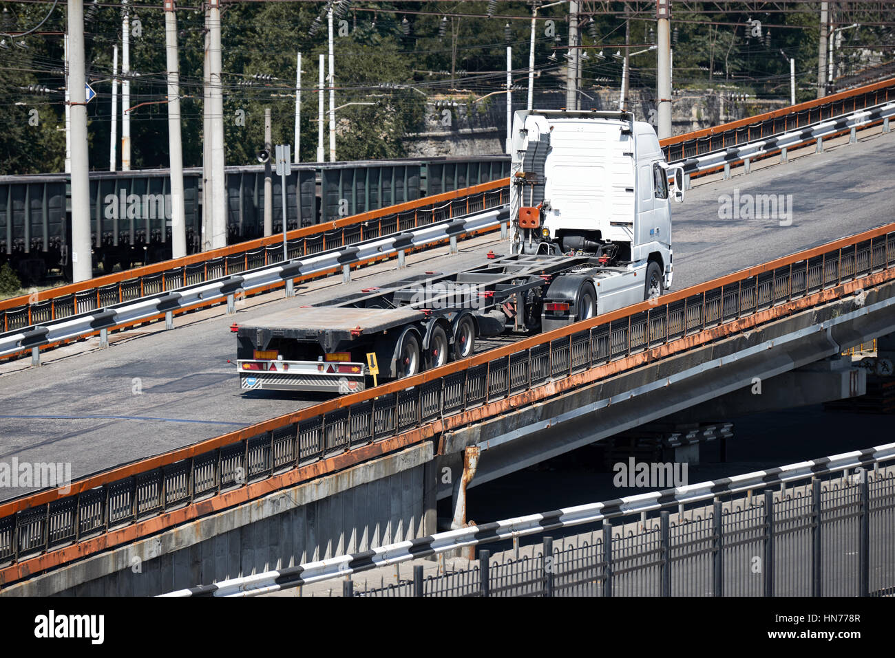 one white truck on road rides up over the bridge, industrial ...