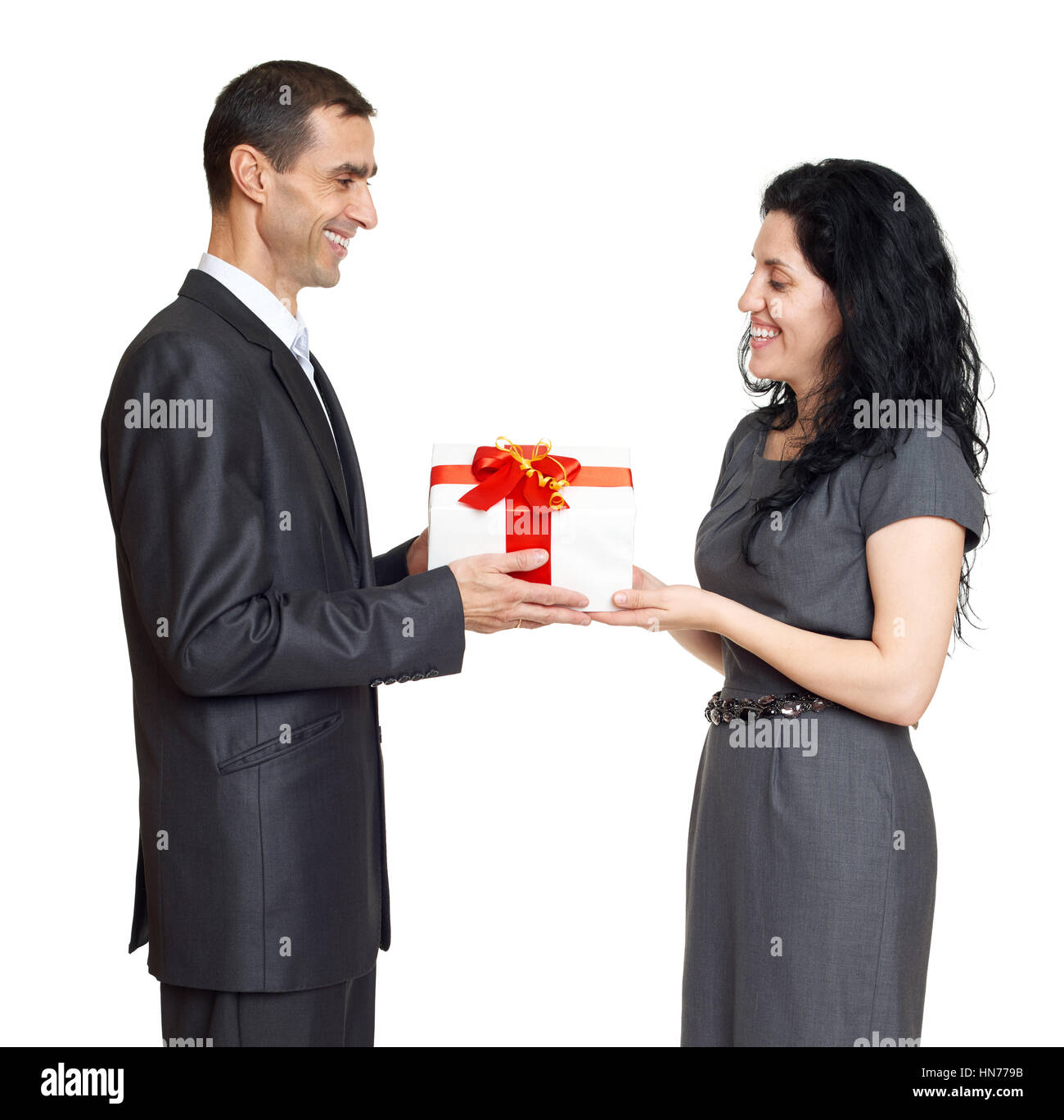 romantic couple with gift box, people dressed in black suit, man gives ...