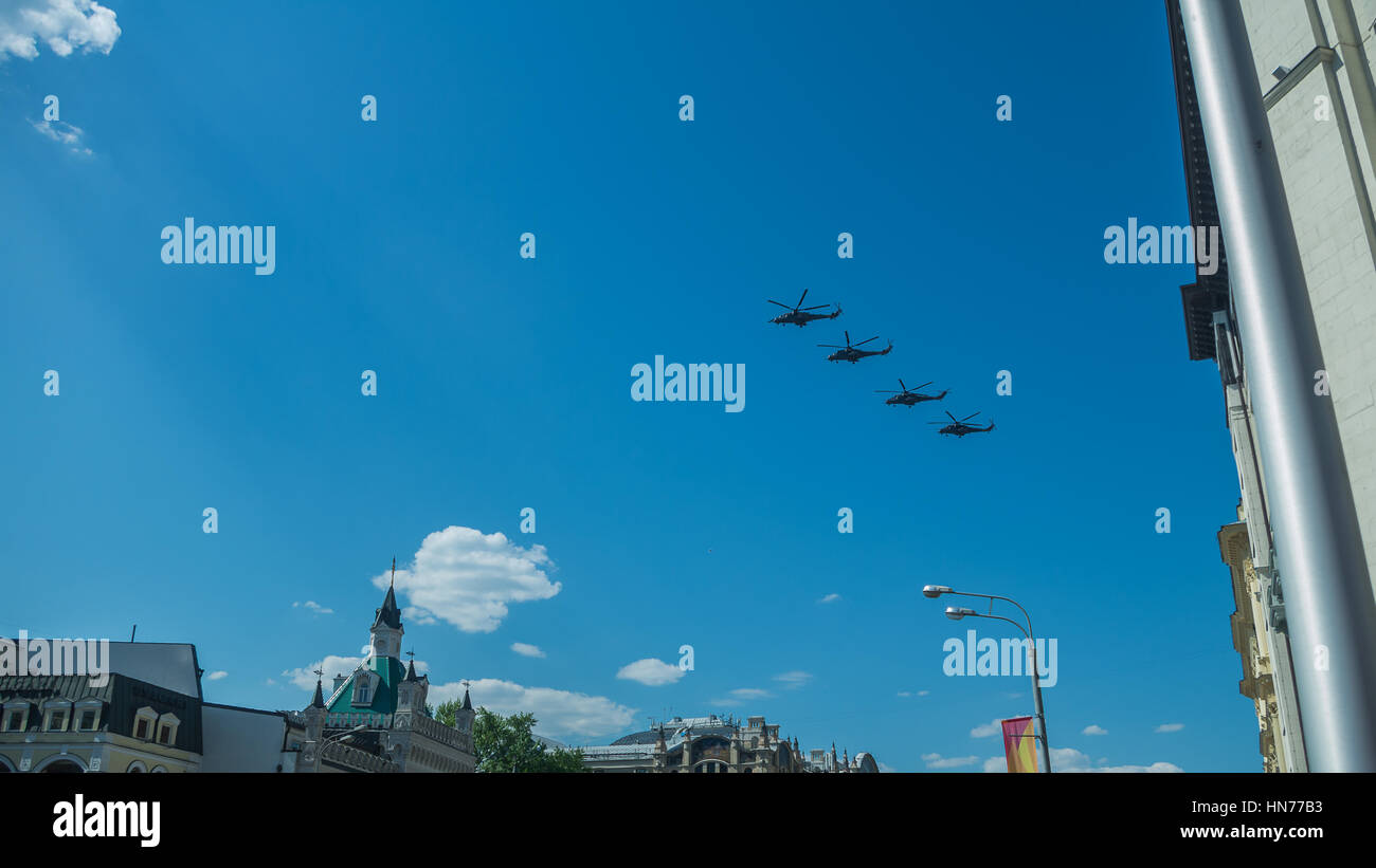 Four combat helicopters flying over the city during a parade Stock ...