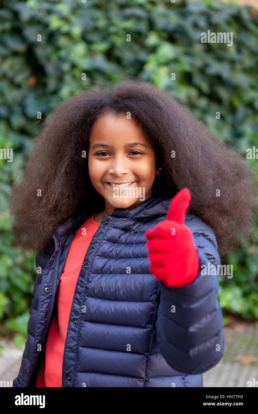 Pretty girl with long afro hair in the garden with a blue coat Stock ...