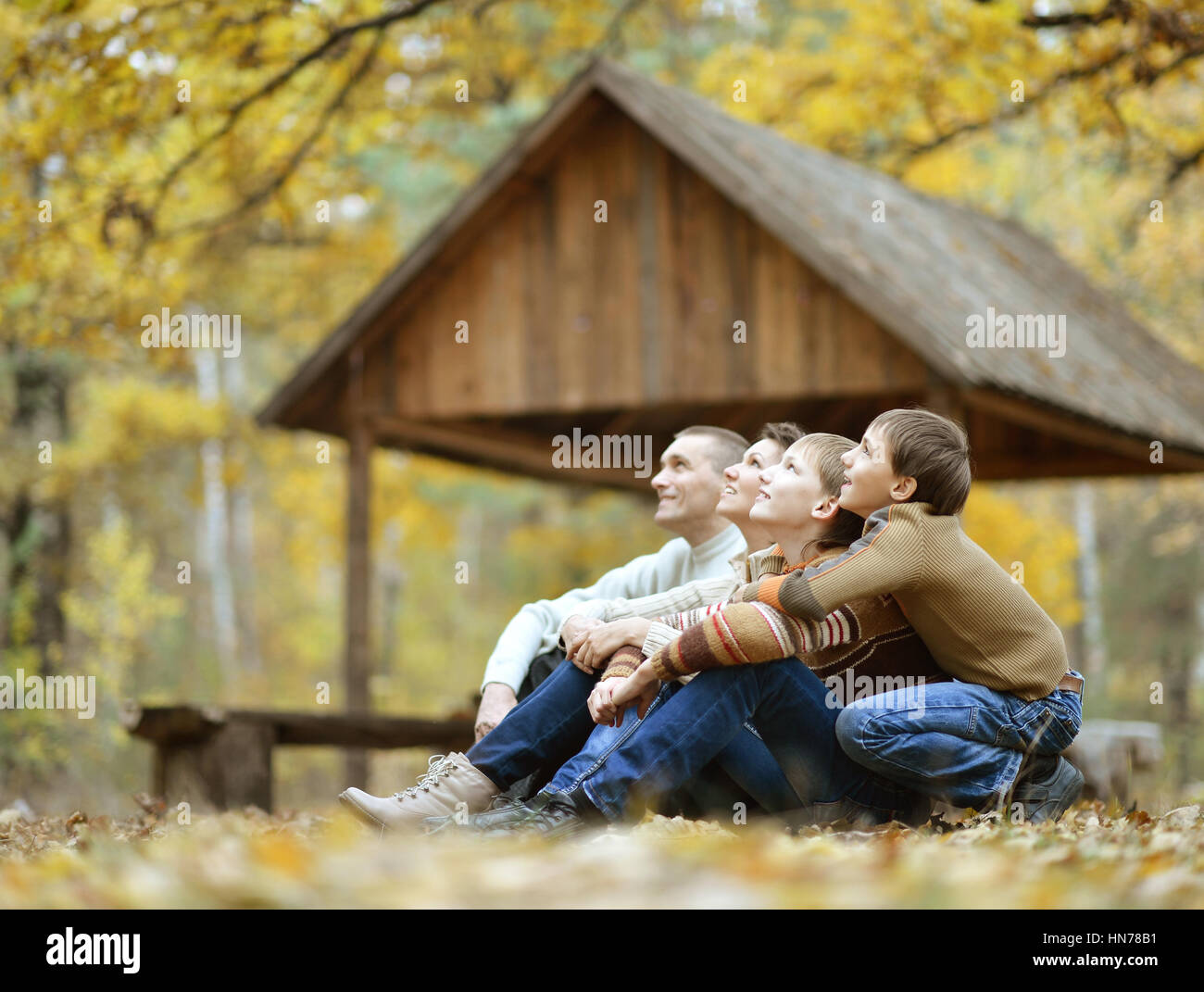 Family relax in autumn park Stock Photo - Alamy