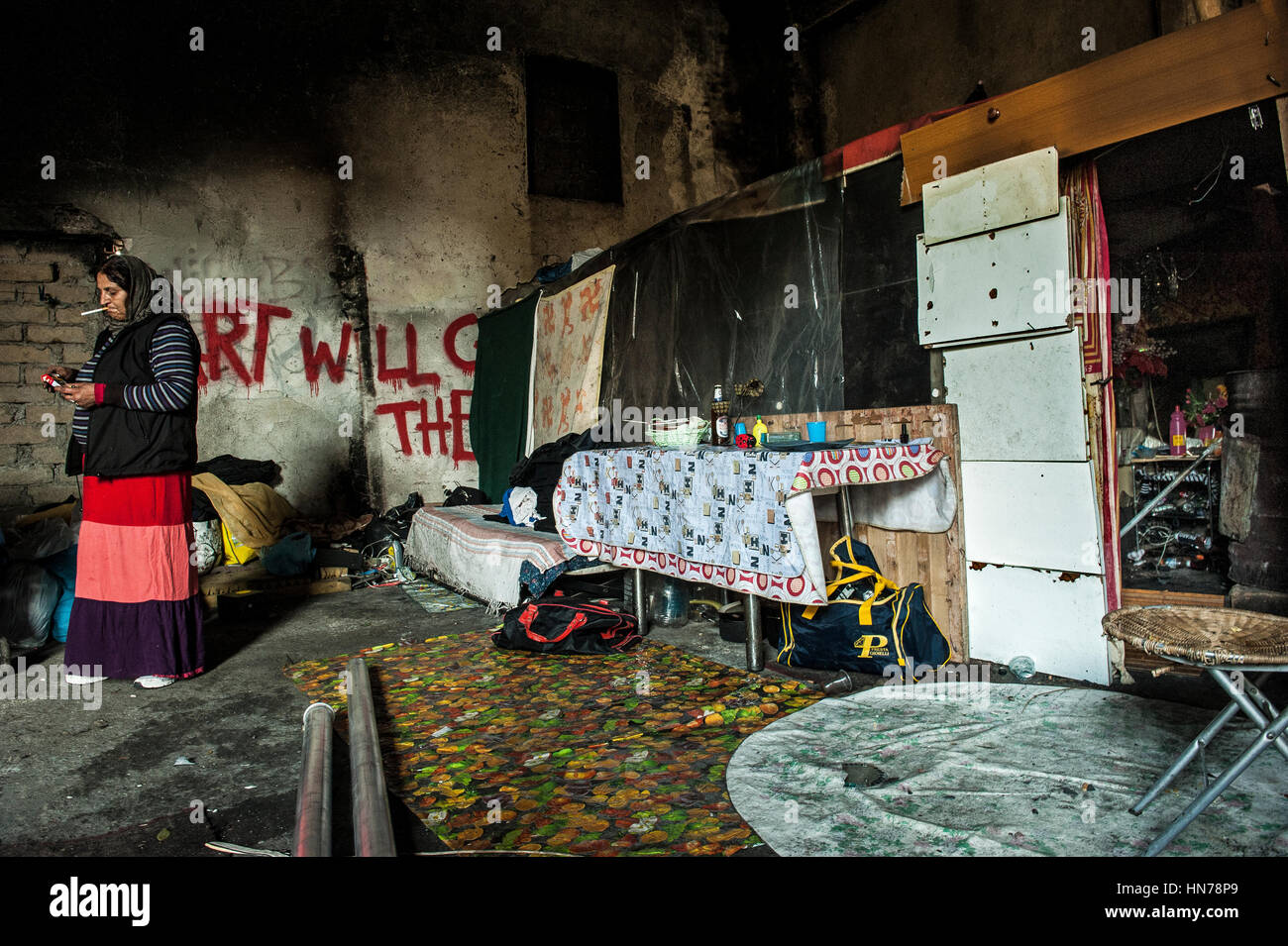 The wife of the guardian Tito smoking near their shack, at the bottom ...
