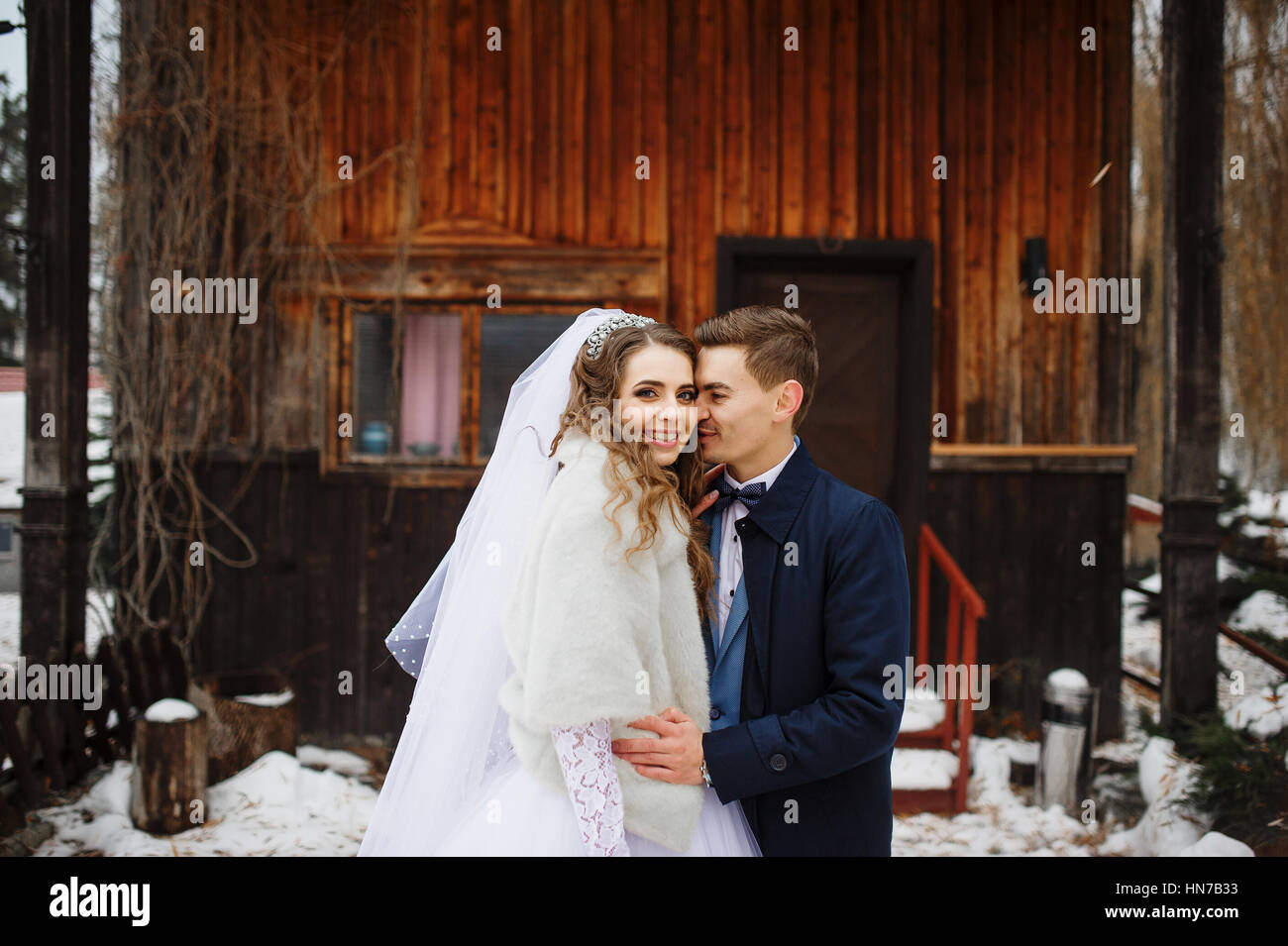 Sincere wedding couple background old wooden house on winter day Stock ...