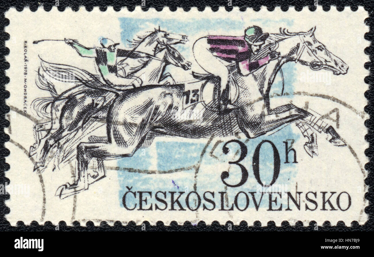 A postage stamp printed in Czechoslovakia shows a Horse racing ...